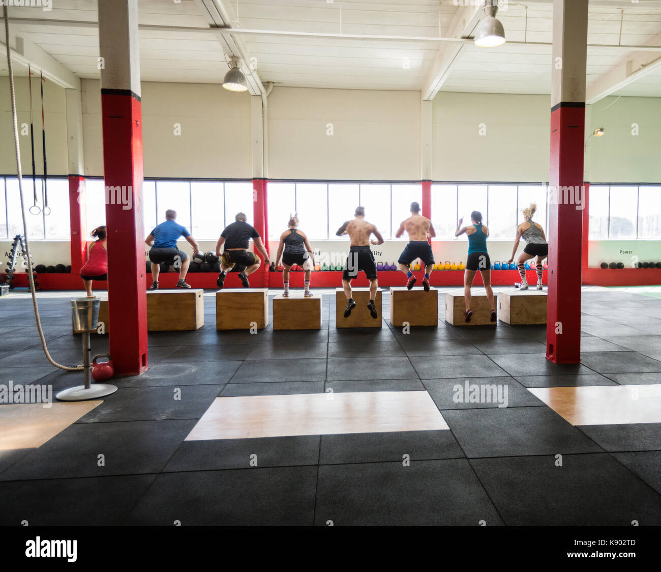 Clients Performing Box Jumps In Fitness Studio Stock Photo - Alamy