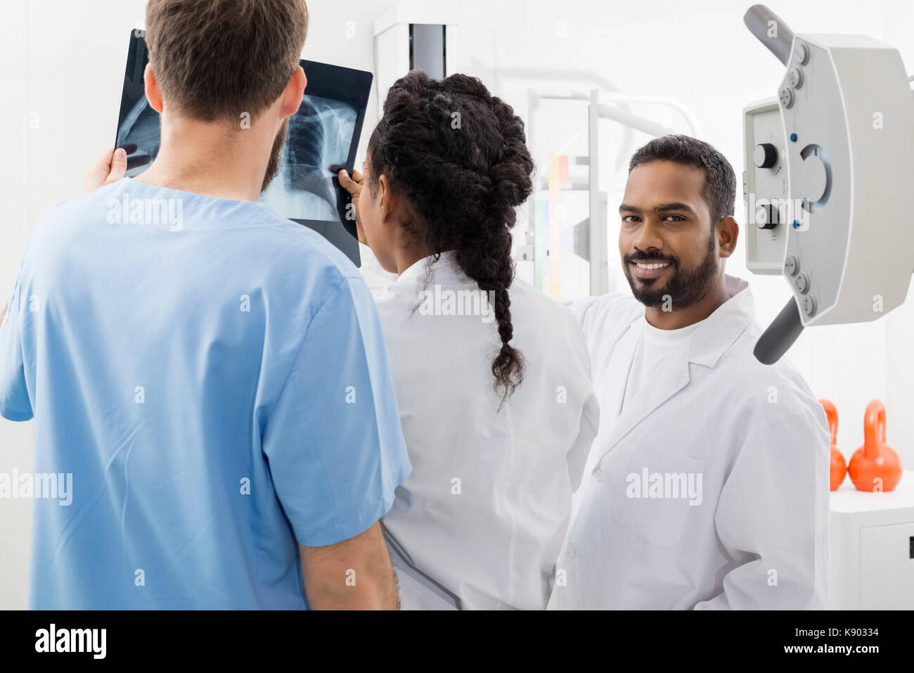 Radiologist With Colleagues Analyzing X-ray In Hospital Stock Photo - Alamy