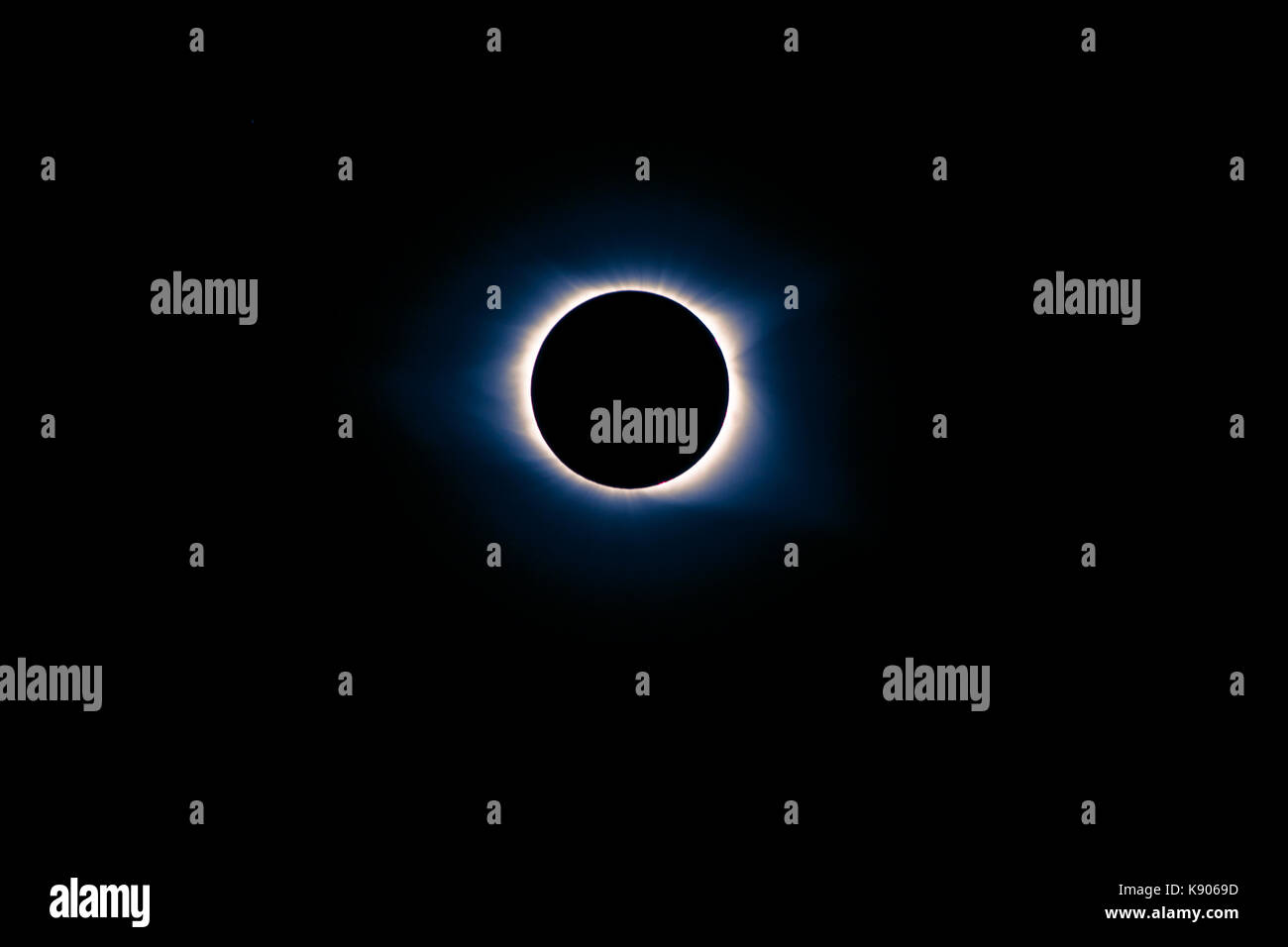 solar eclipse during totality with blue and pink hues Stock Photo - Alamy
