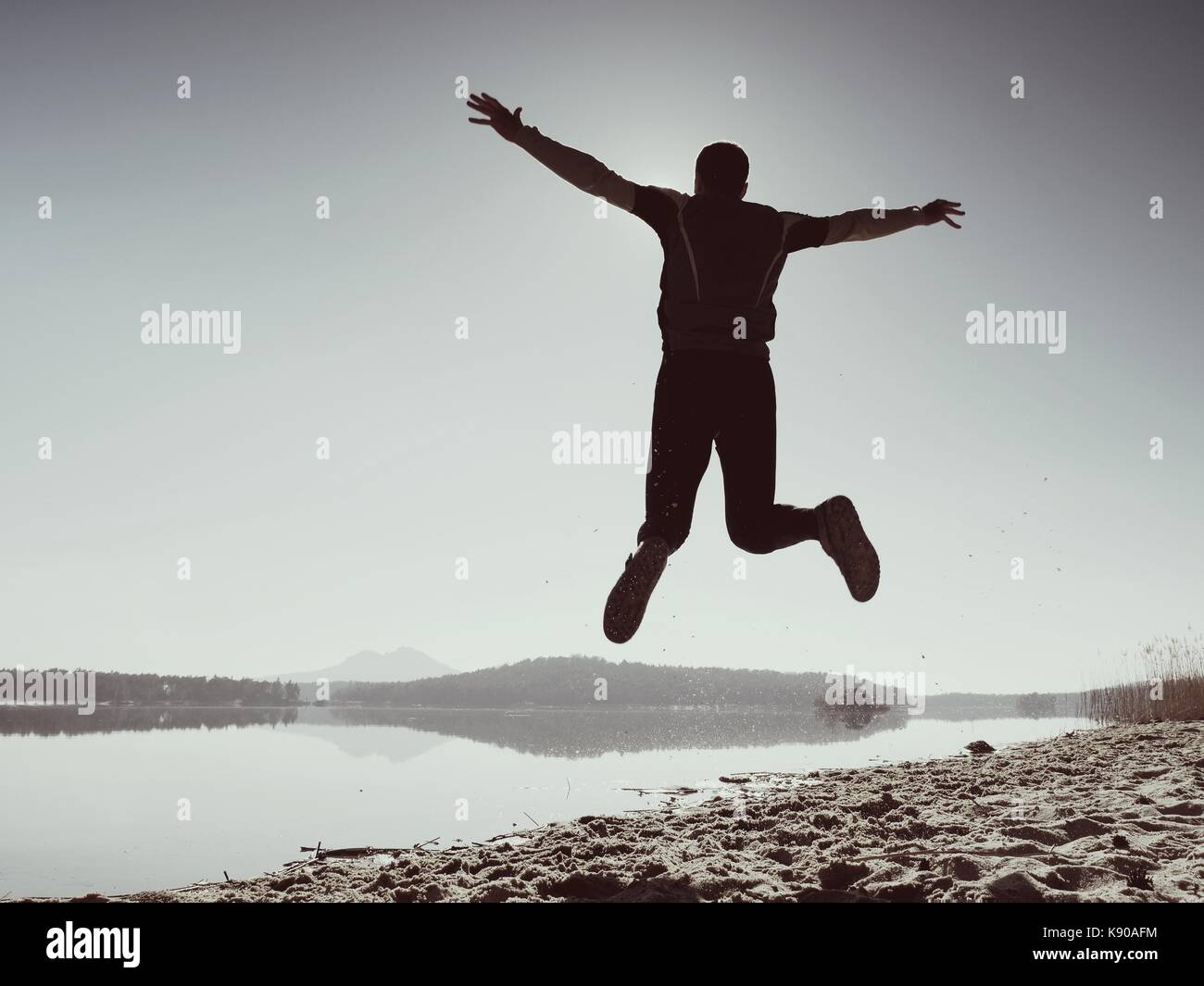 Man crazy jumping on beach. Sportsman flying on beach during the ...