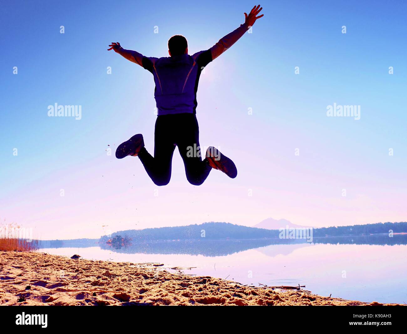Man crazy jumping on beach. Sportsman flying on beach during the ...
