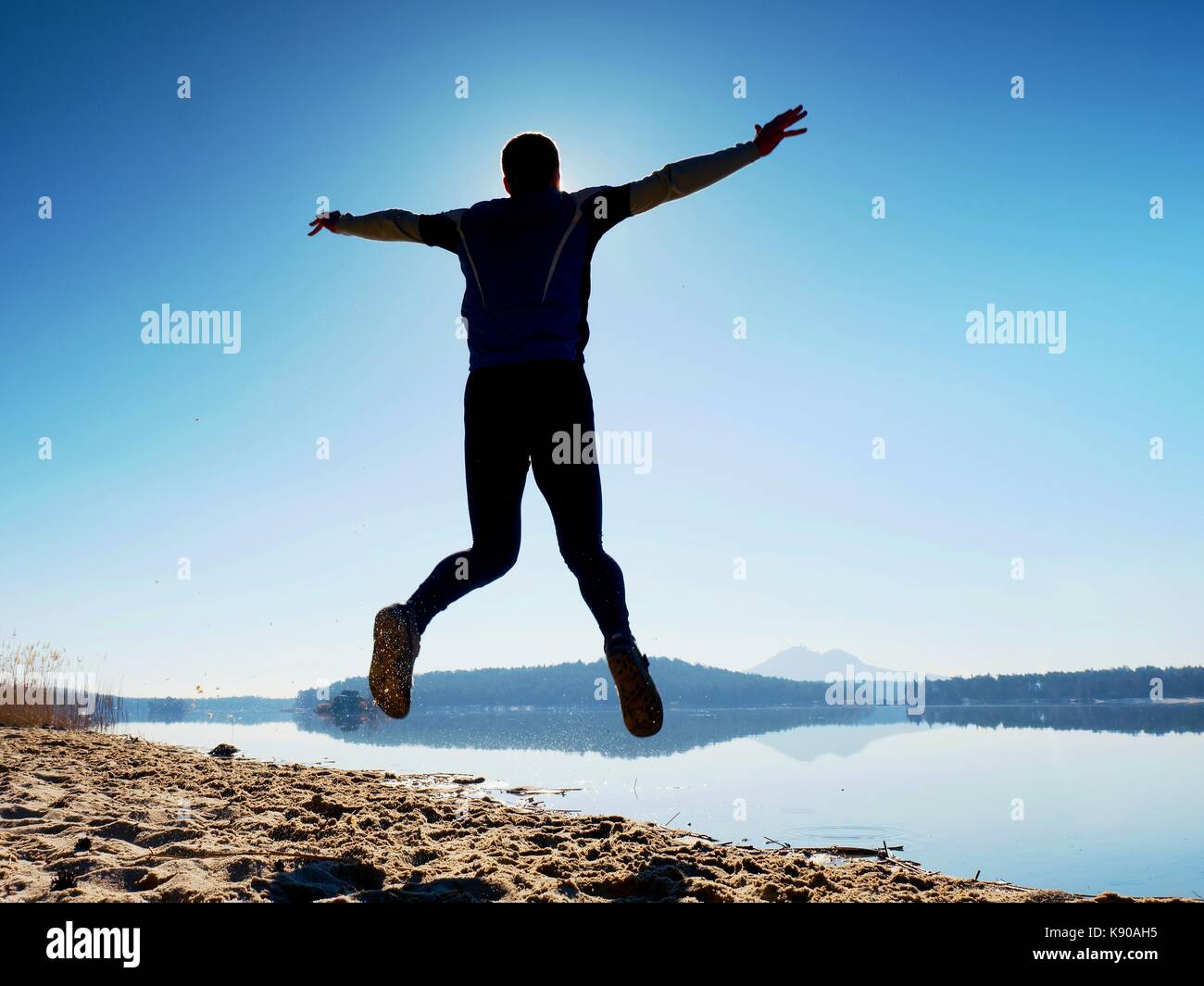 Man crazy jumping on beach. Sportsman flying on beach during the ...