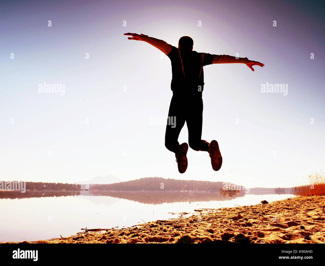 Man crazy jumping on beach. Sportsman flying on beach during the ...