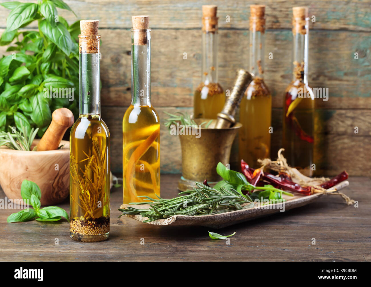 Olive oil with different spices on a old wooden table Stock Photo - Alamy
