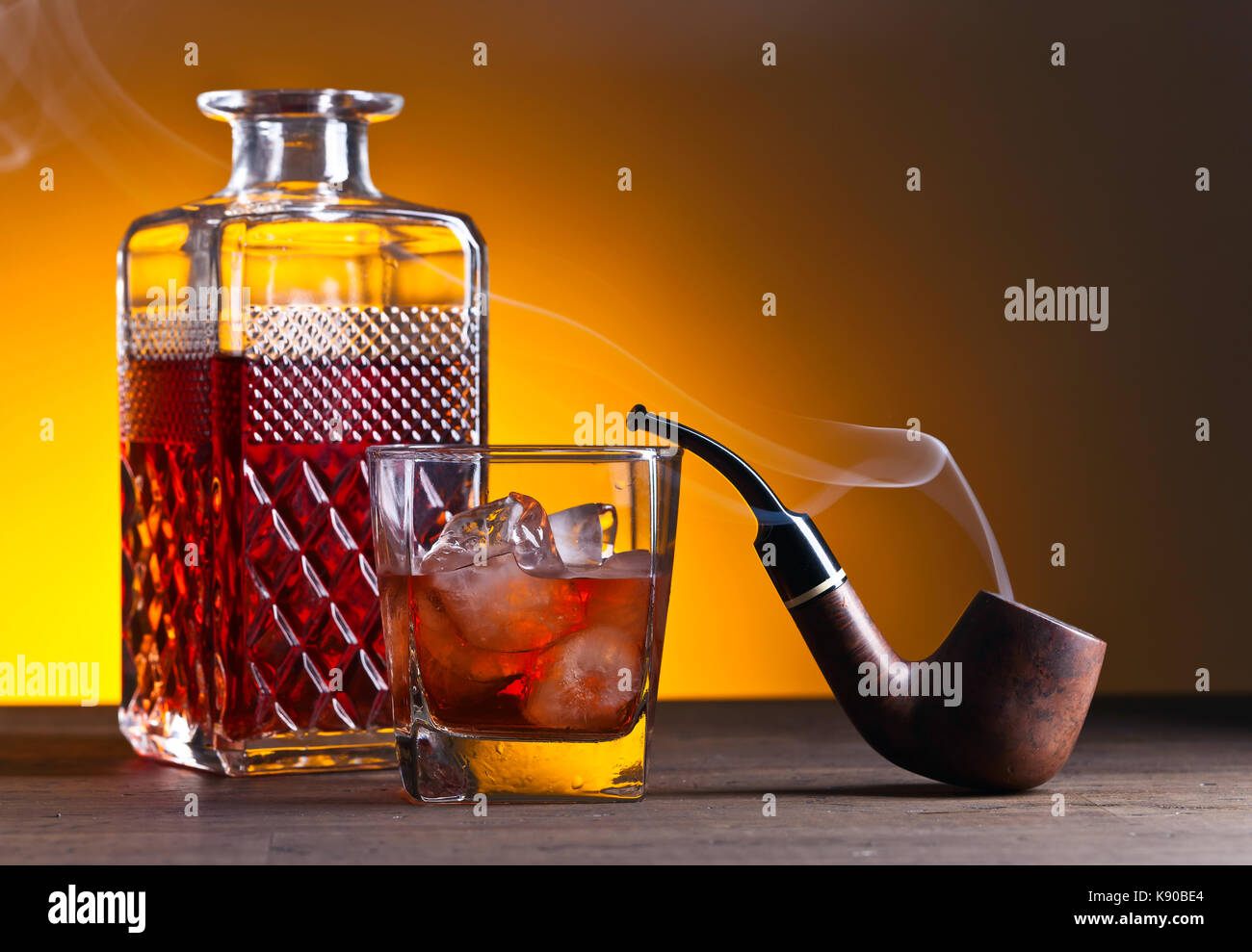 Glass of whiskey and pipe on a old wooden table Stock Photo - Alamy