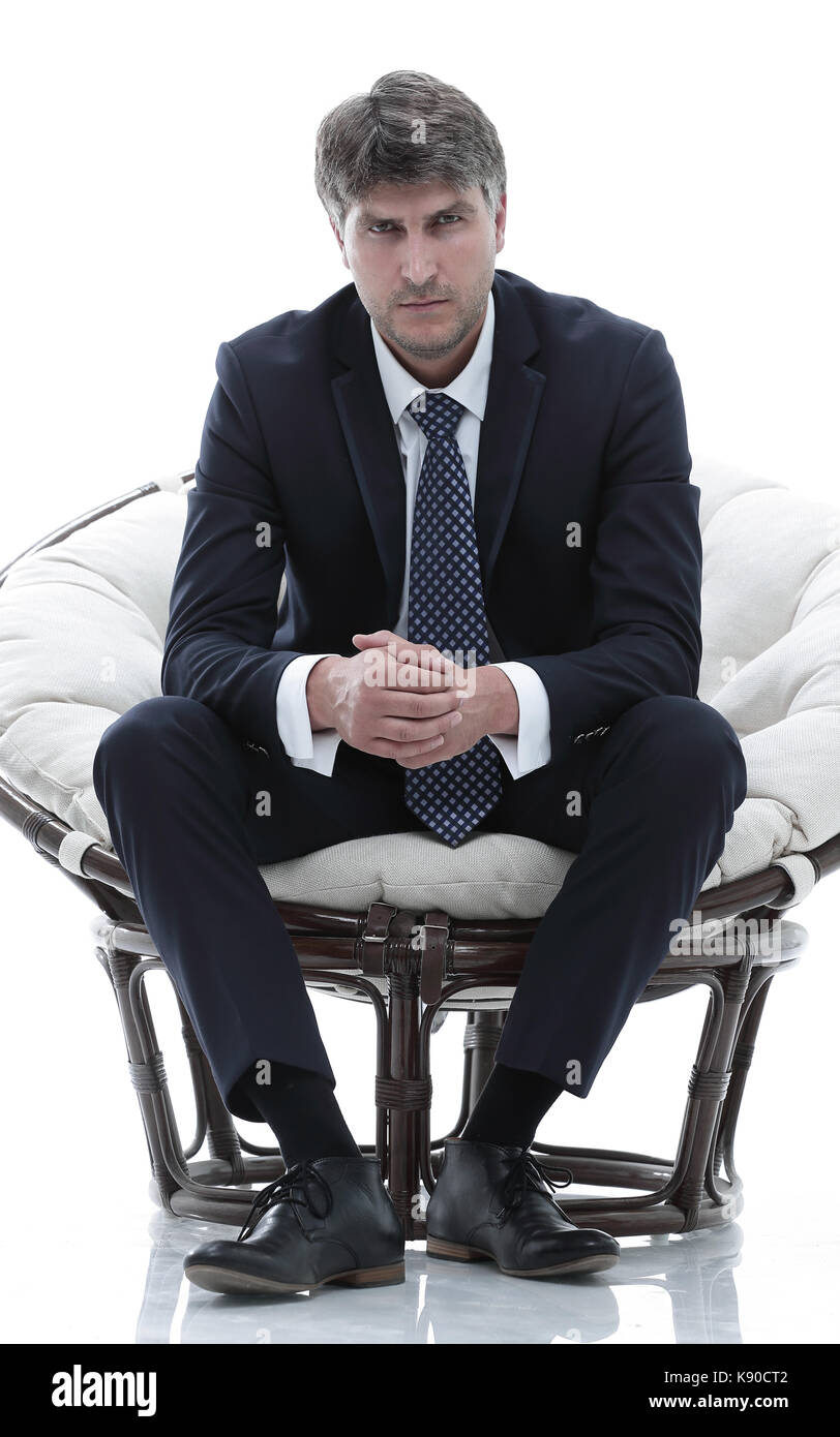 Tired business man sitting in a large comfortable chair Stock Photo - Alamy