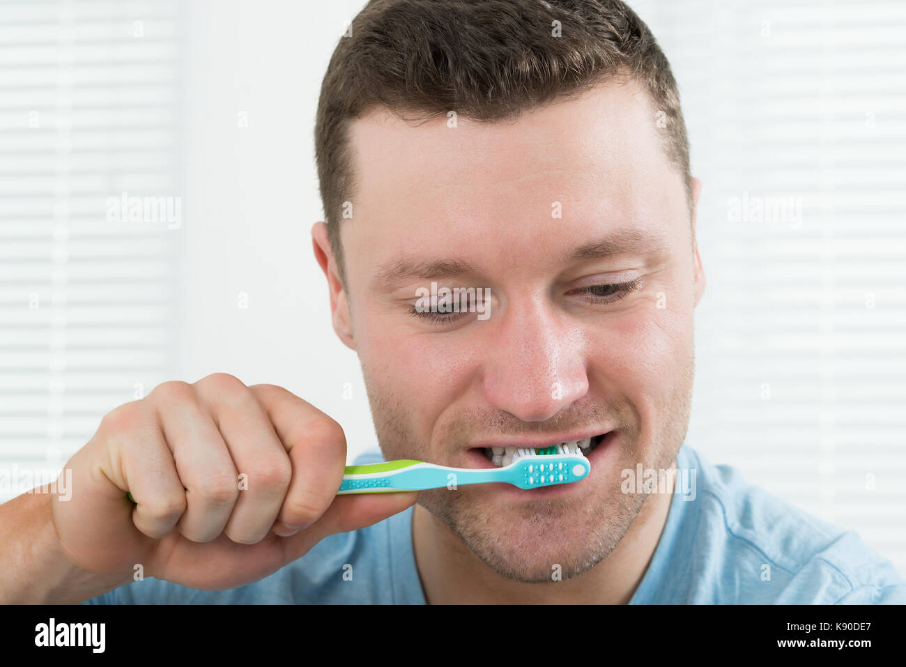 Closeup of mid adult man brushing teeth at home Stock Photo - Alamy