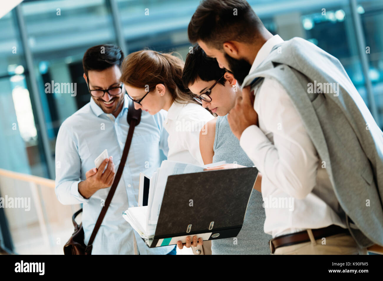 Group of young perspective businesspeople having discussion Stock Photo ...