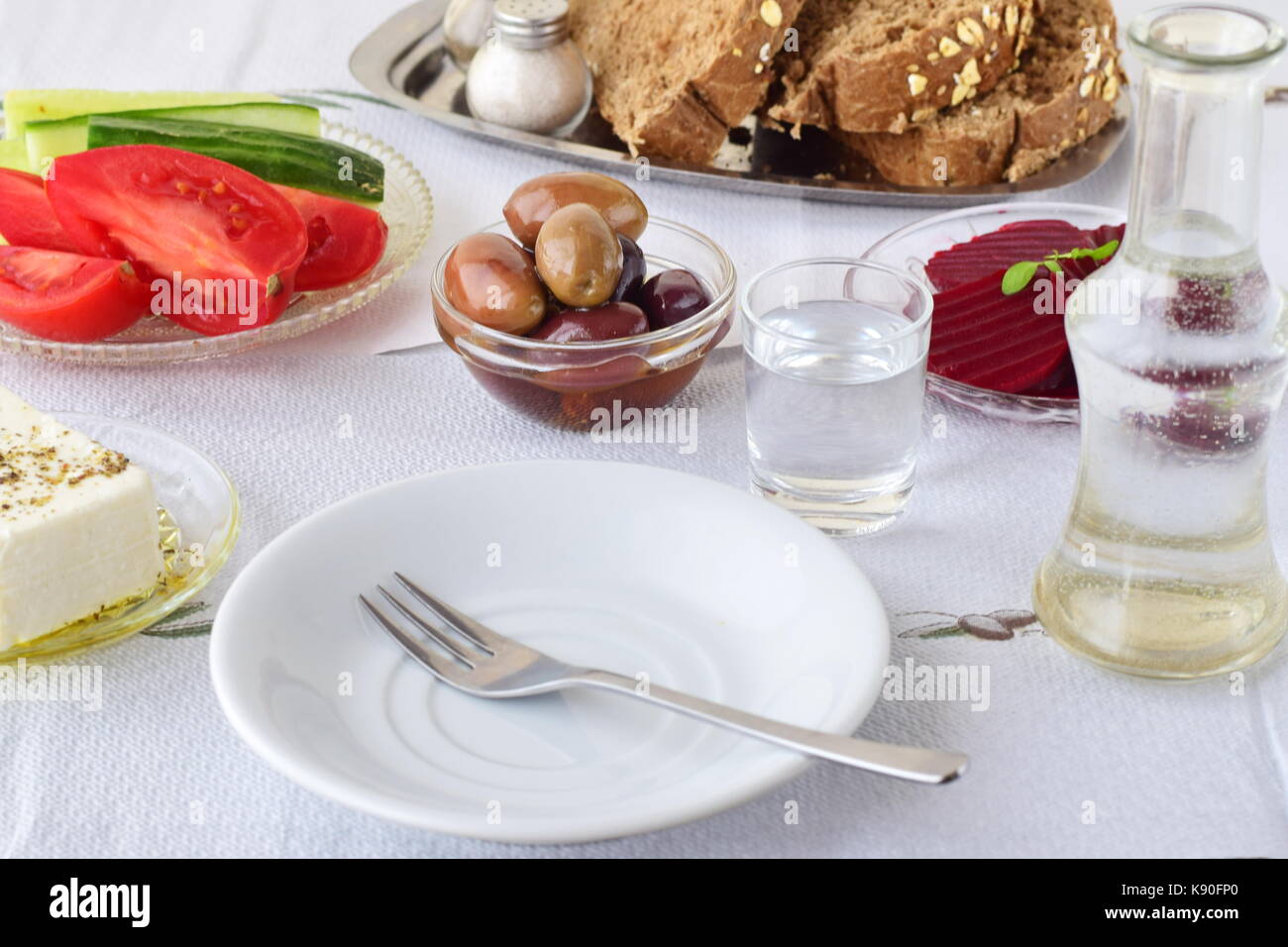 Greek food, mezedes. Jars with olive oil and vine vinegar, olives,feta ...
