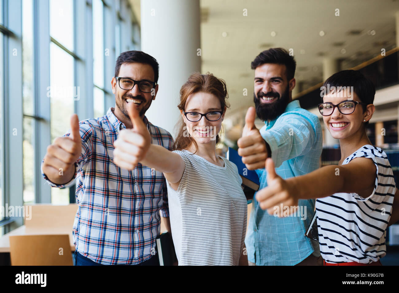 Group of cheerful students posing faculty hallway Stock Photo - Alamy