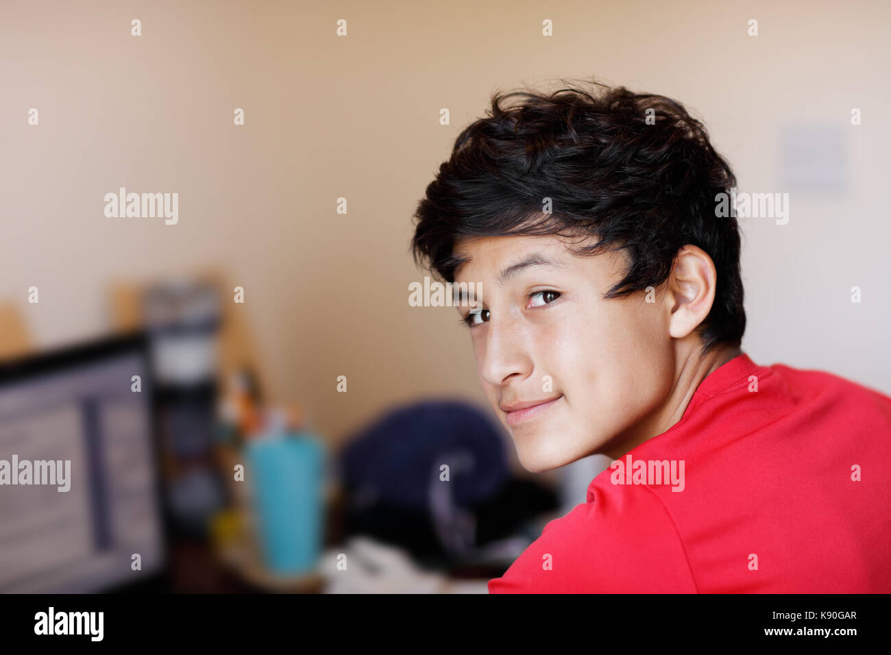 Young teen boy doing homework on his computer Stock Photo - Alamy