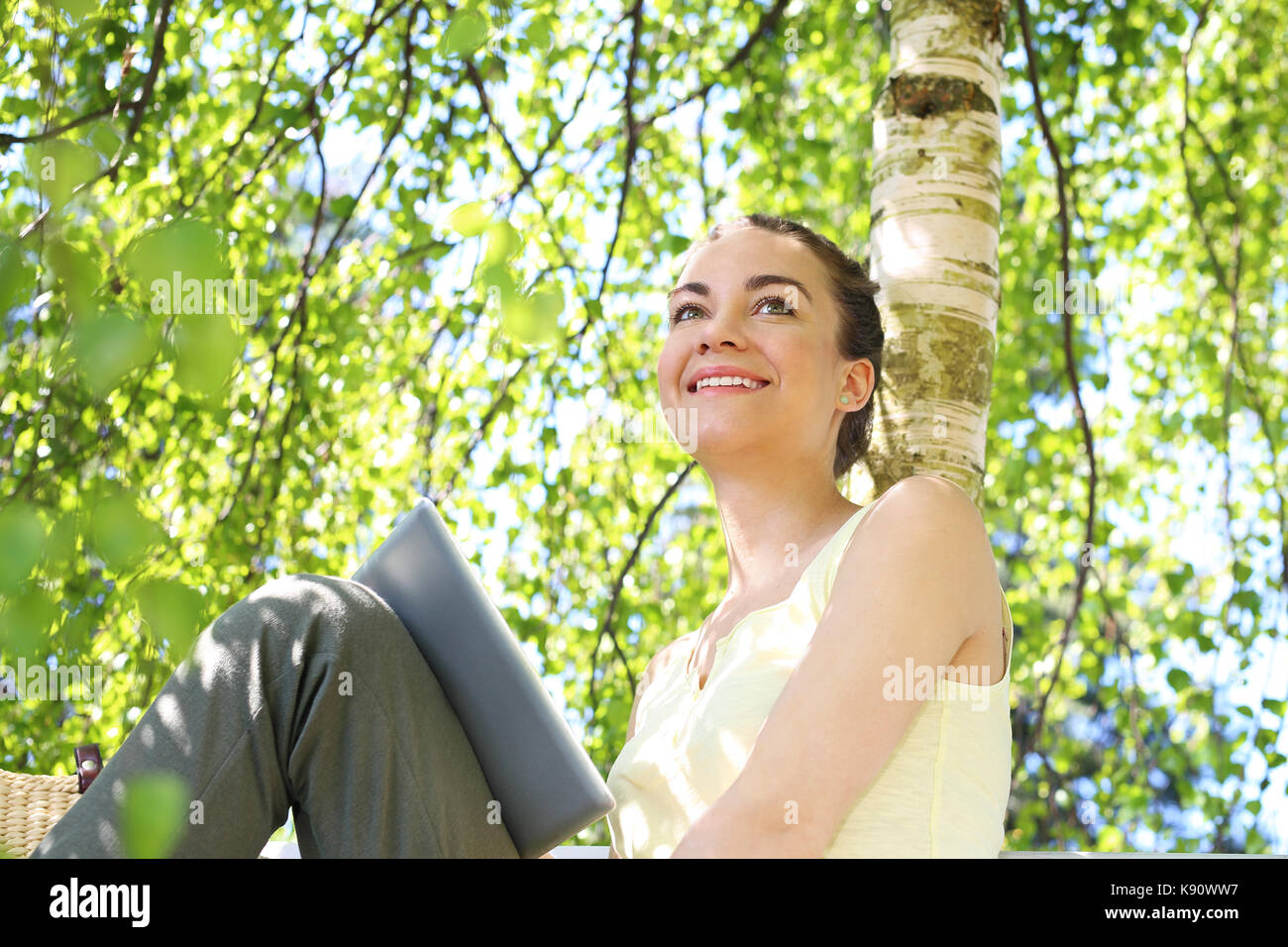 Relax under the tree. Woman resting in the shade of a tree Stock Photo ...