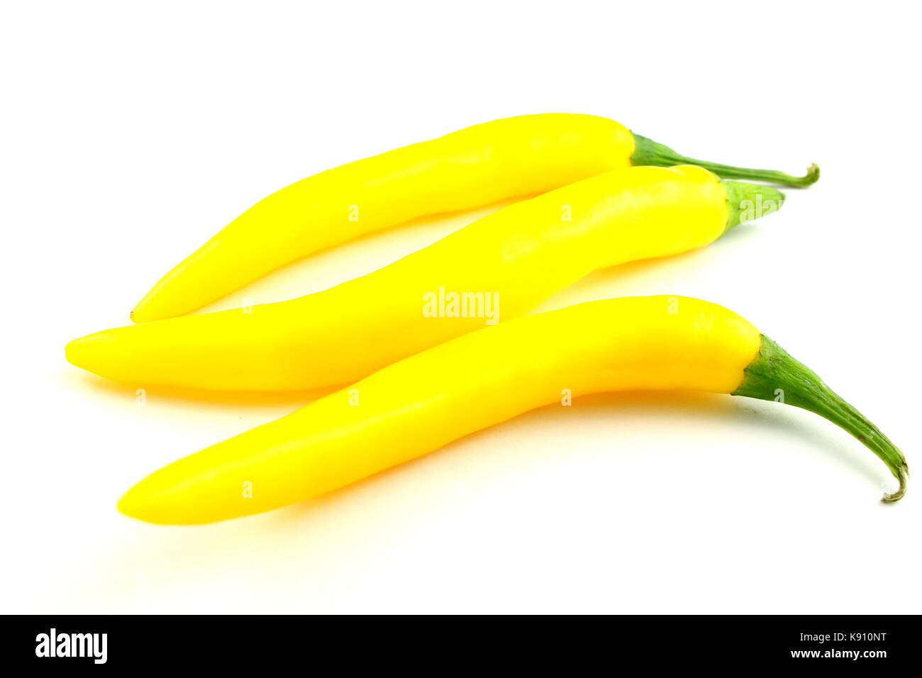 composition of fresh yellow chili peppers isolated in a white ...