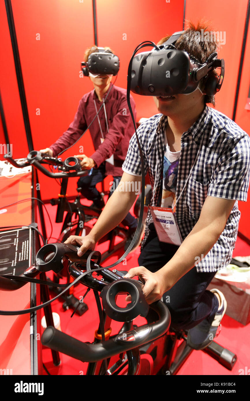 Visitors test a virtual reality glasses at the Tokyo Game Show (TGS ...