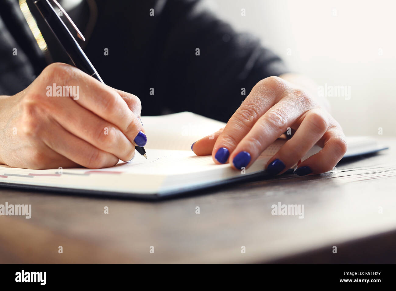 Writing with a pen. Important notes, planning a day in the calendar ...