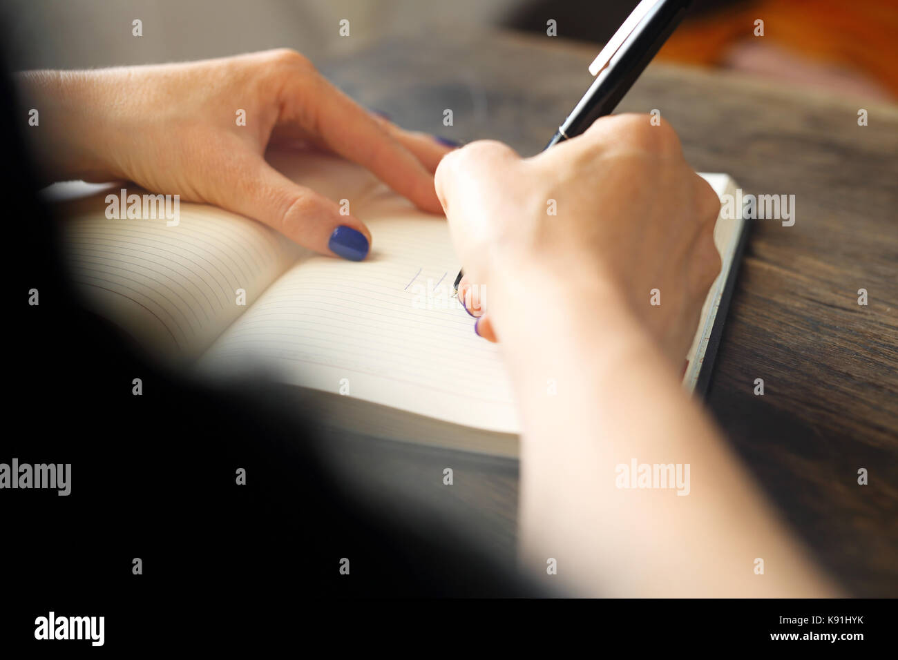 Writing with a pen. Important notes, planning a day in the calendar ...