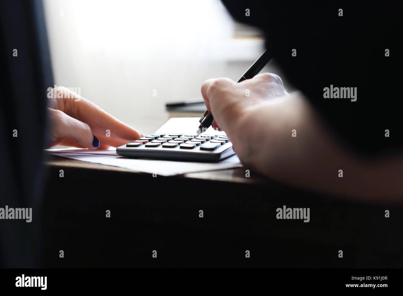 Business.Counting on the calculator Stock Photo - Alamy