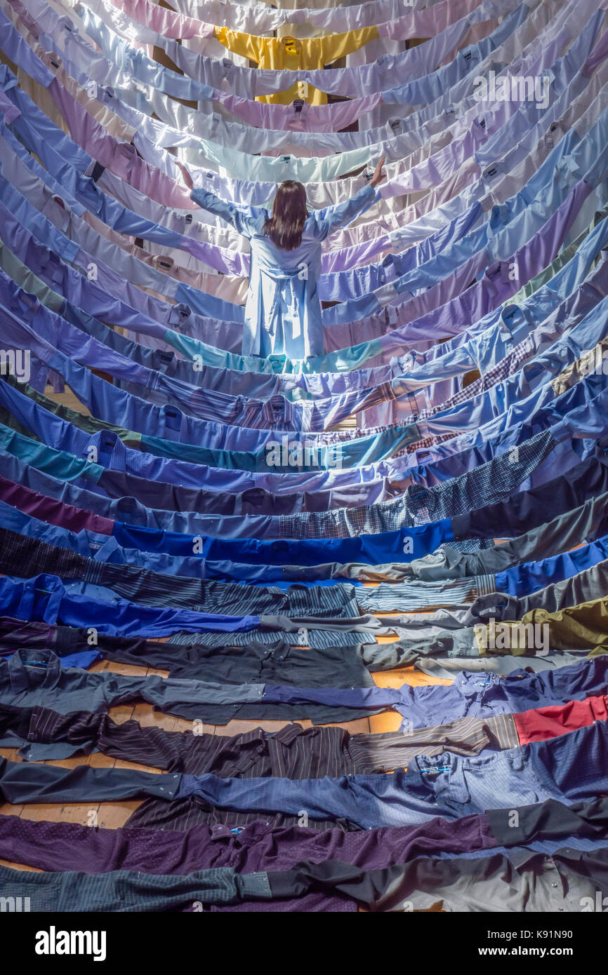 Shirts art installation with model in similar coloured coat Stock Photo ...