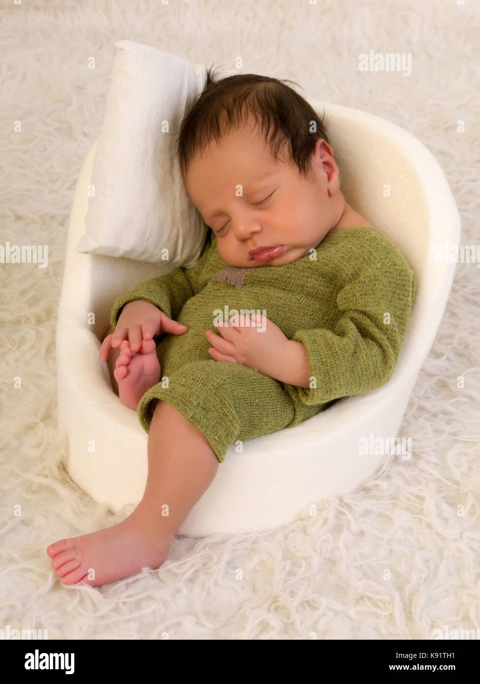 Adorable African newborn baby sleeping in a baby seat Stock Photo - Alamy