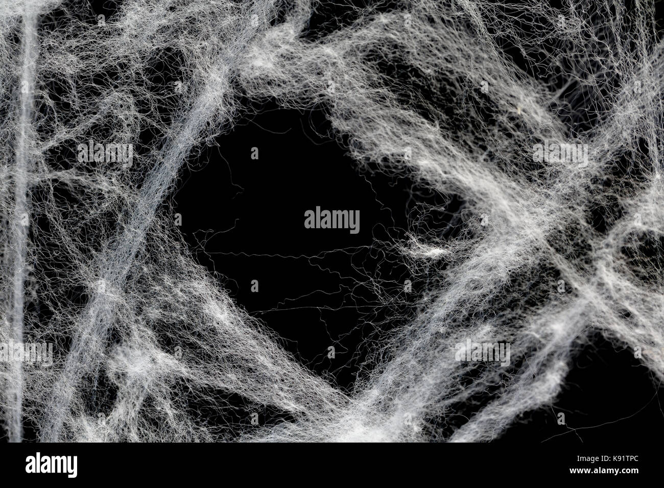 Cobweb or spider's web against a black background, to be used as ...