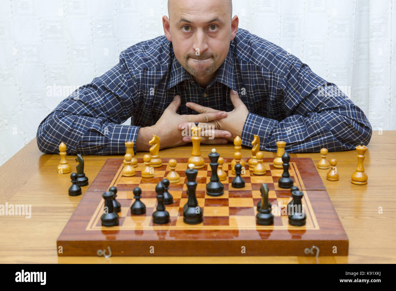 Man playing chess on light background. closeup of young man thinking ...