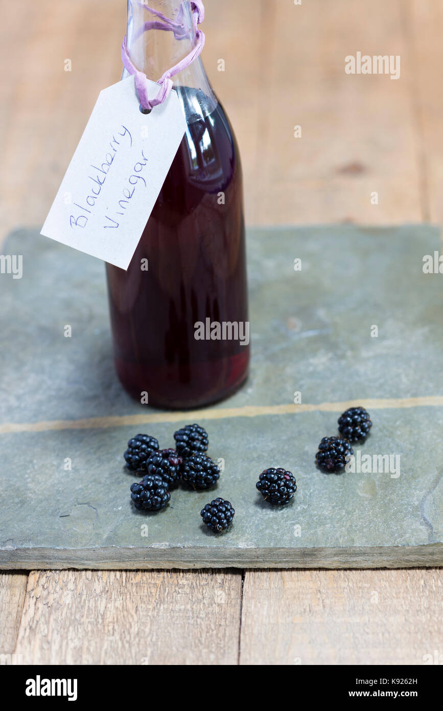 Homemade blackberry vinegar on a slate board Stock Photo - Alamy