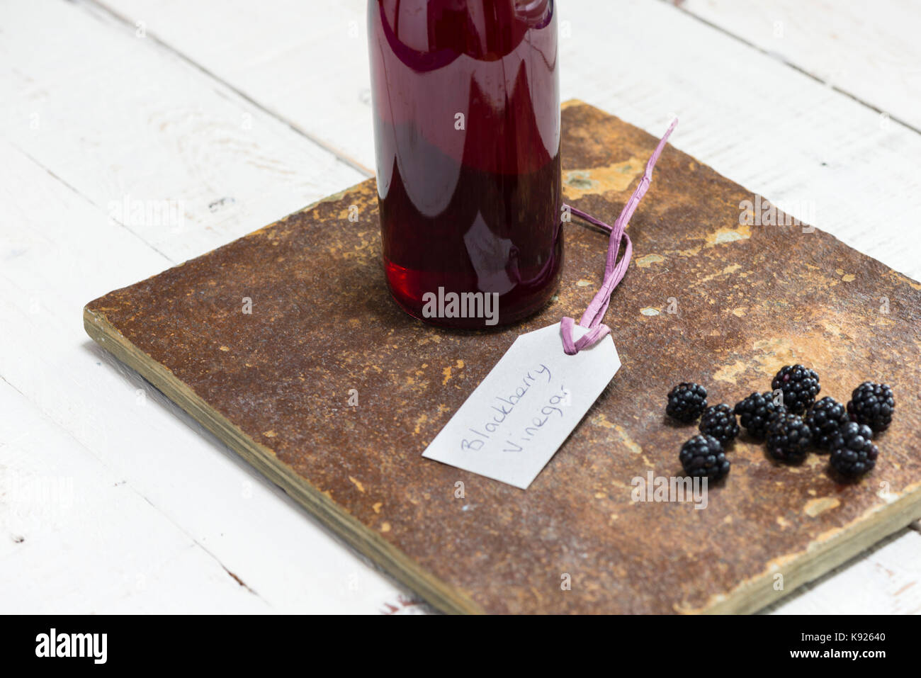 Homemade blackberry vinegar on a slate board Stock Photo - Alamy