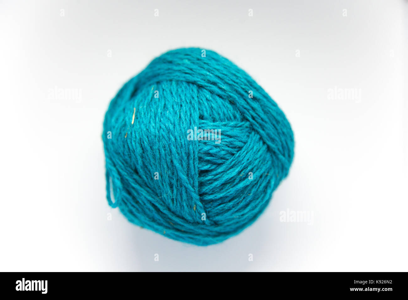Small colorful ball of wool yarn on a white background. Hand craft ...