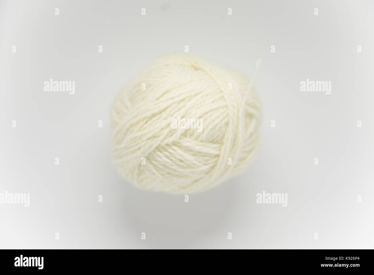 Small colorful ball of wool yarn on a white background. Hand craft ...