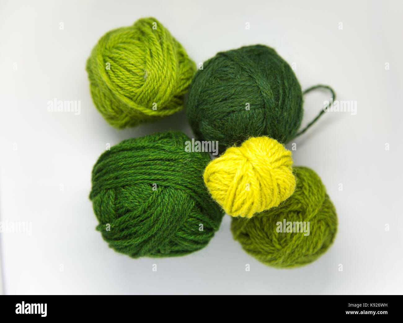 Small colorful ball of wool yarn on a white background. Hand craft ...