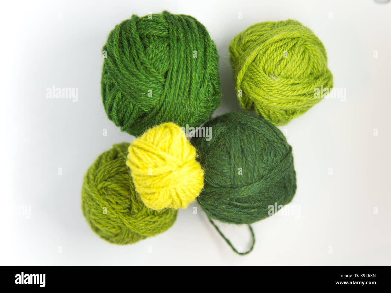 Small colorful ball of wool yarn on a white background. Hand craft ...