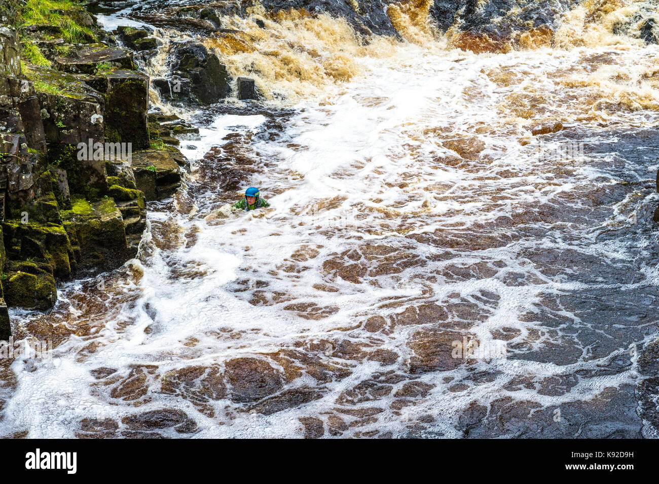 Gorge walking in the River Tees during stormy weather and swollen river ...