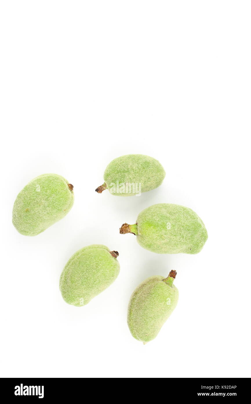 composition of fresh green almond fruits isolated on a white background ...