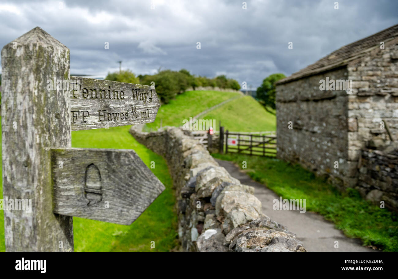 Sign for the Pennine Way mounted onto a wood post in a small Yorkshire ...