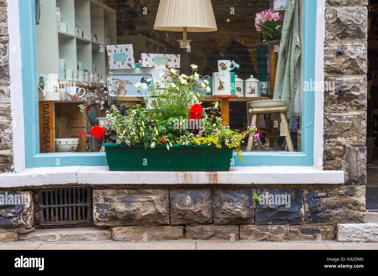 Flowers in a plant container outside a shop window Stock Photo - Alamy