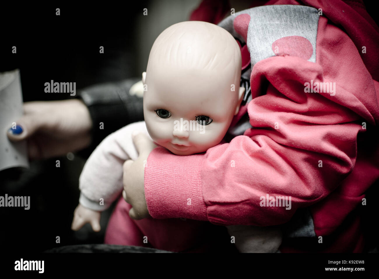 Hands holding toy doll hi-res stock photography and images - Alamy