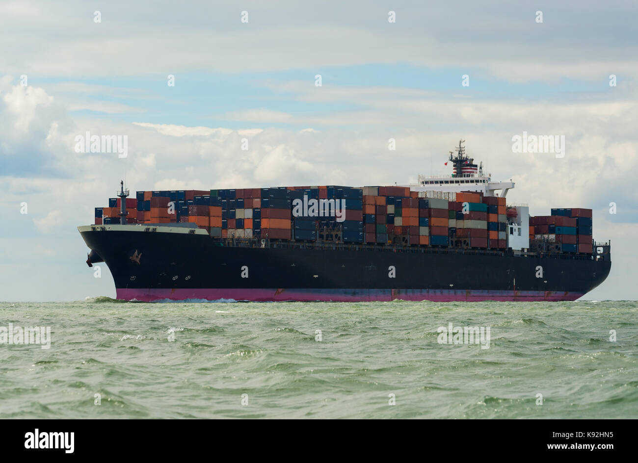 Container cargo transport ship sailing at sea Stock Photo - Alamy