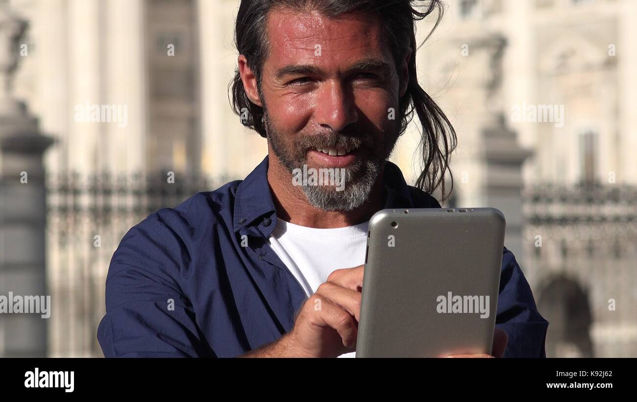 European Male Using Tablet Stock Photo - Alamy