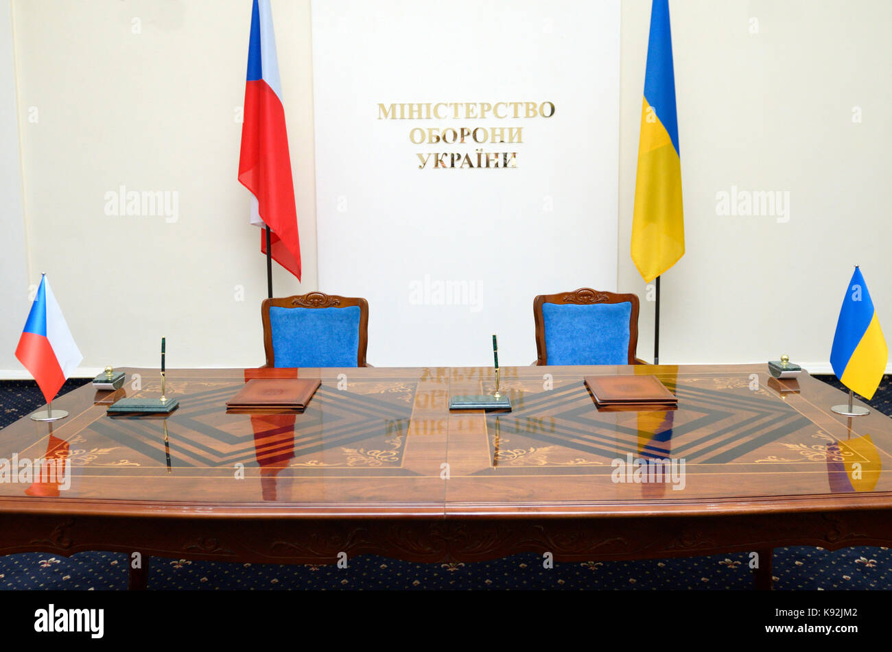 A conference room in a Public institution. Flags, desk and stationary ...