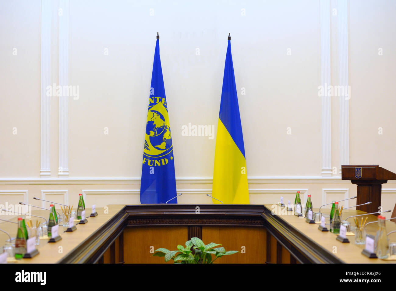 A conference room in a Public institution. Flags, desk and stationary ...