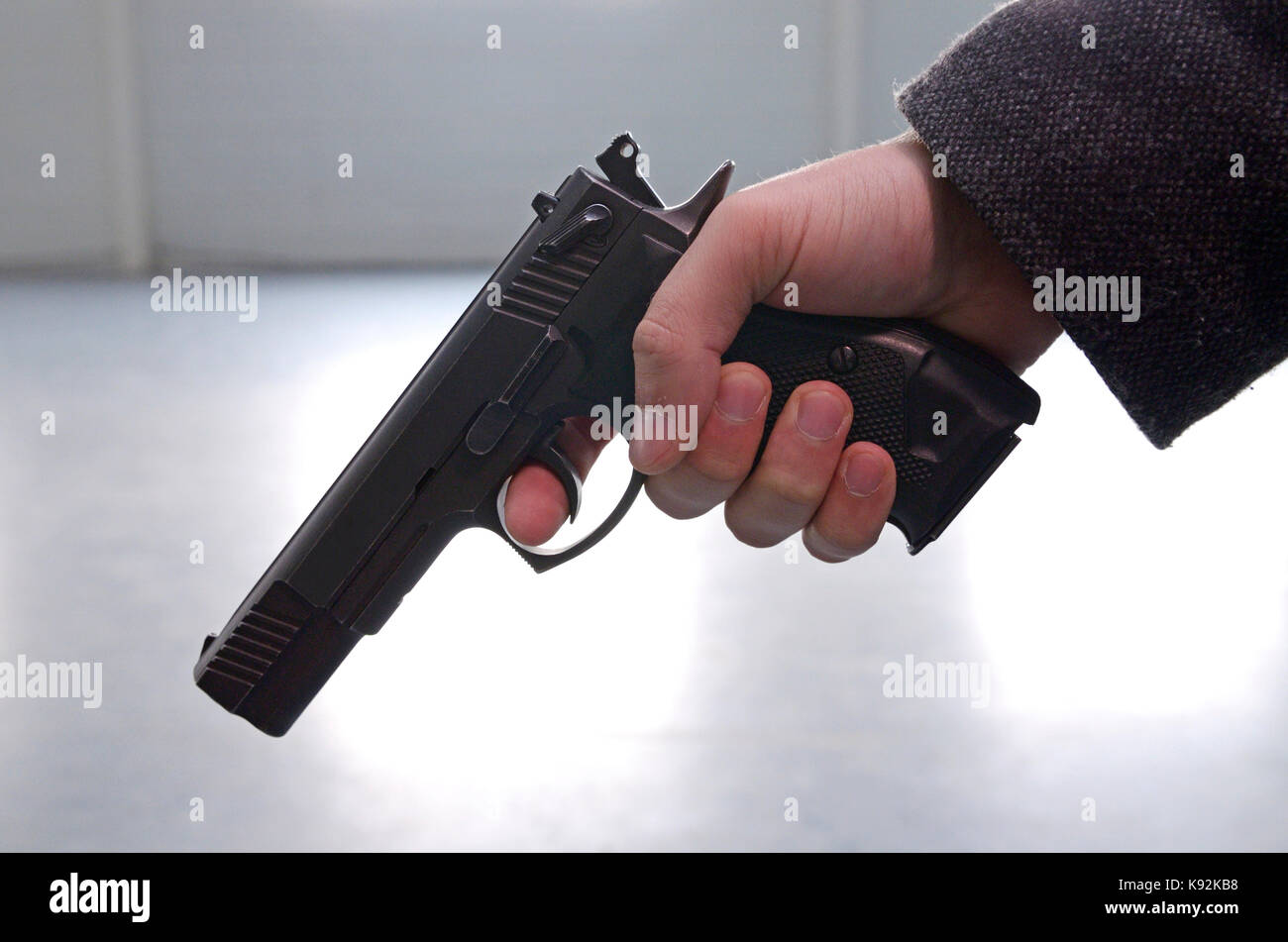 Hand aiming with a pistol Stock Photo - Alamy