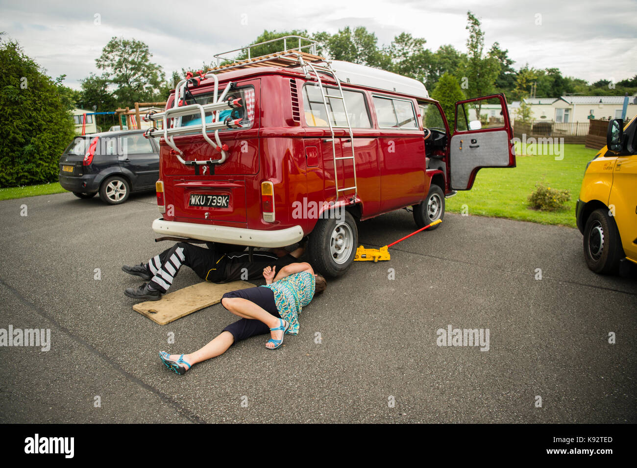 Roadside repairs: An AA (Automobile Association) repair man working to ...