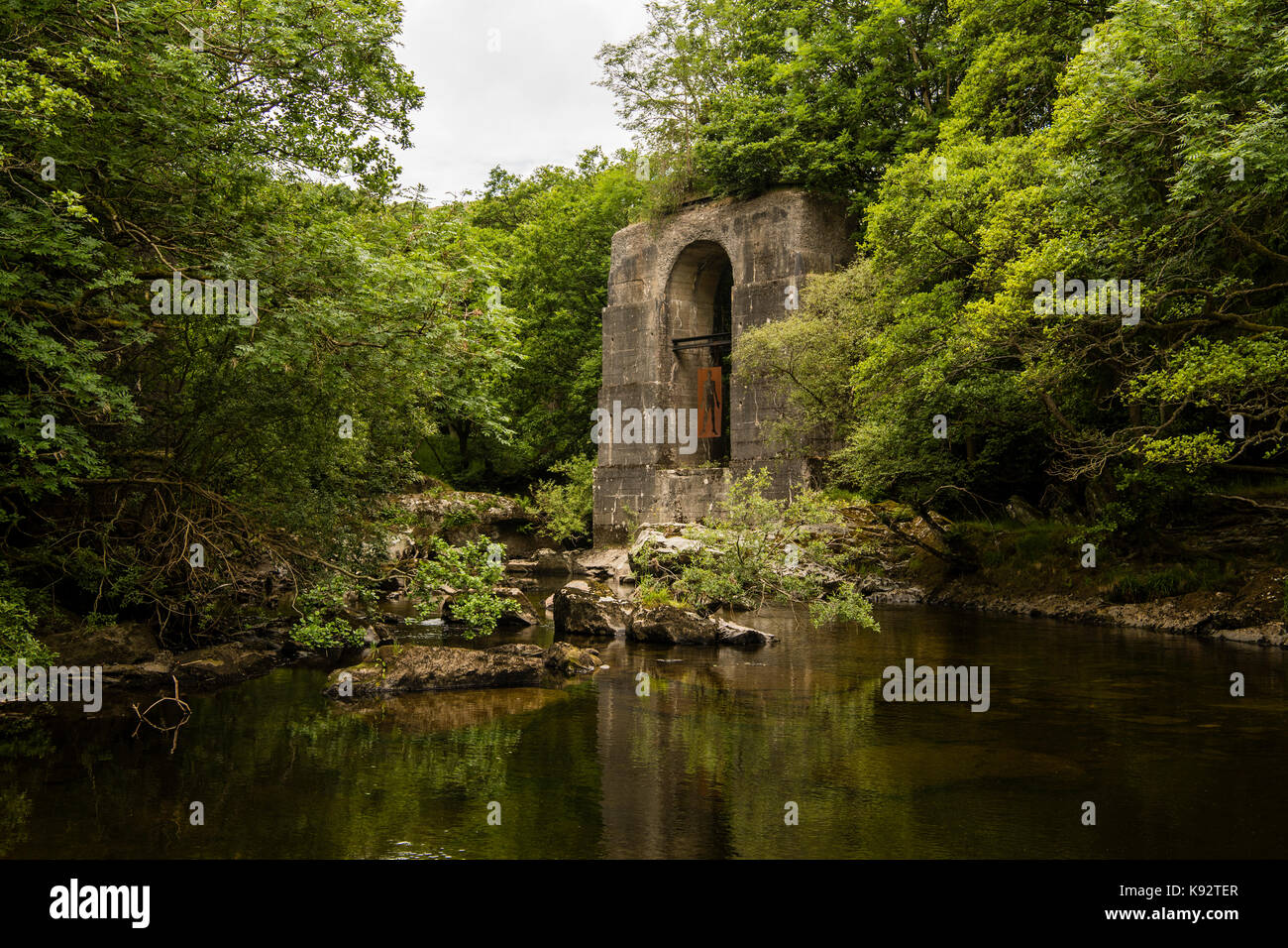 The remains of the old railway bridge over the River Wye near Rhayader ...