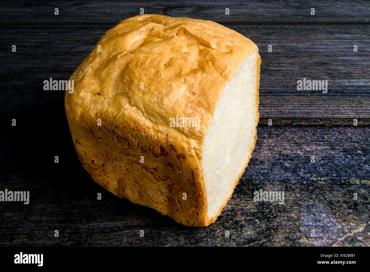 Hand baked and cut loaf of bread on a wooden bench Stock Photo - Alamy