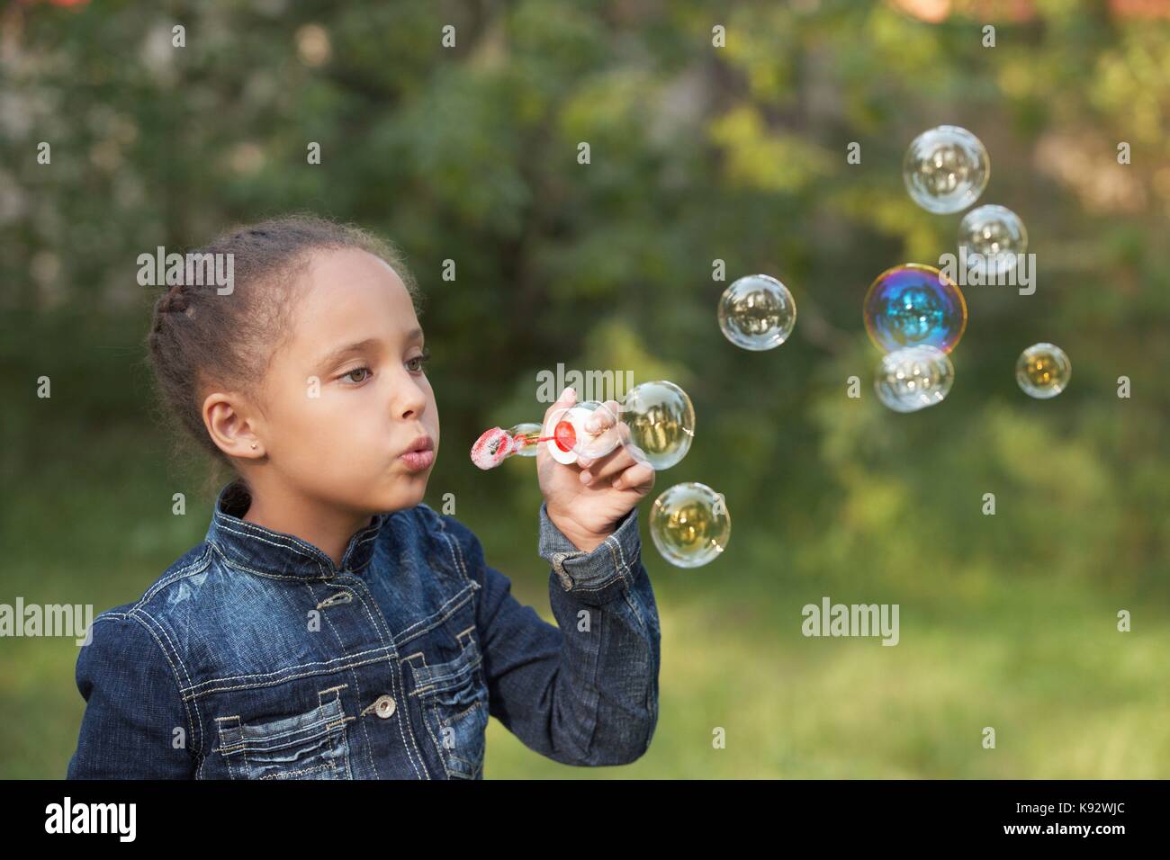 Beautiful girl. Child. Bubble Stock Photo - Alamy