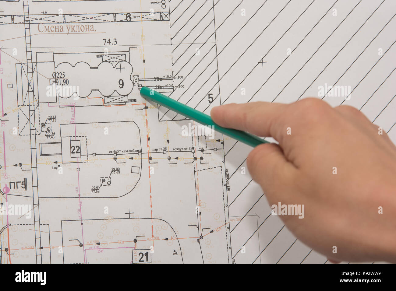 Closeup of man's hands holding blueprints at construction site Stock ...