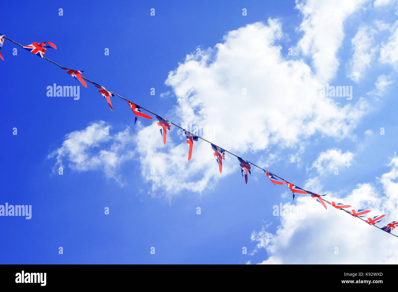 A string of british flag bunting against a blue sky Stock Photo - Alamy