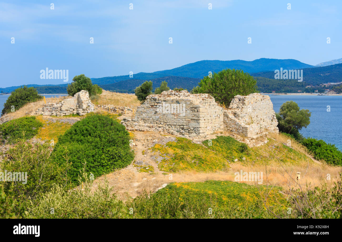 Summer sea coast landscape with old ruins of Ancient City Toroni fort ...