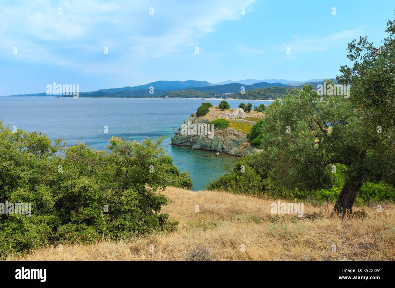 Summer sea coast landscape with old ruins of Ancient City Toroni fort ...