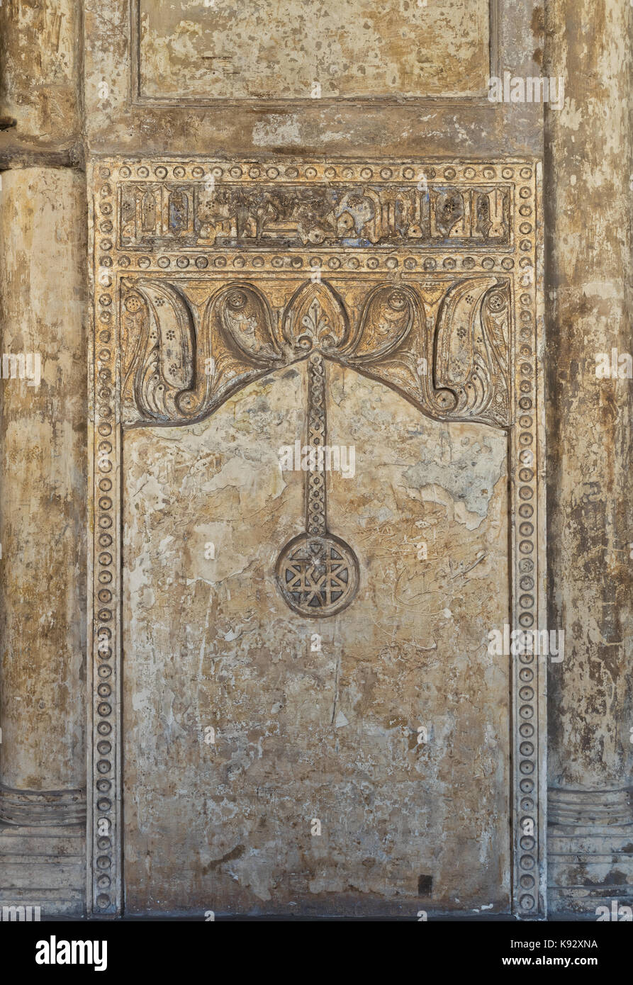 Ornate engraved stone wall with floral patterns and calligraphy, Ibn ...